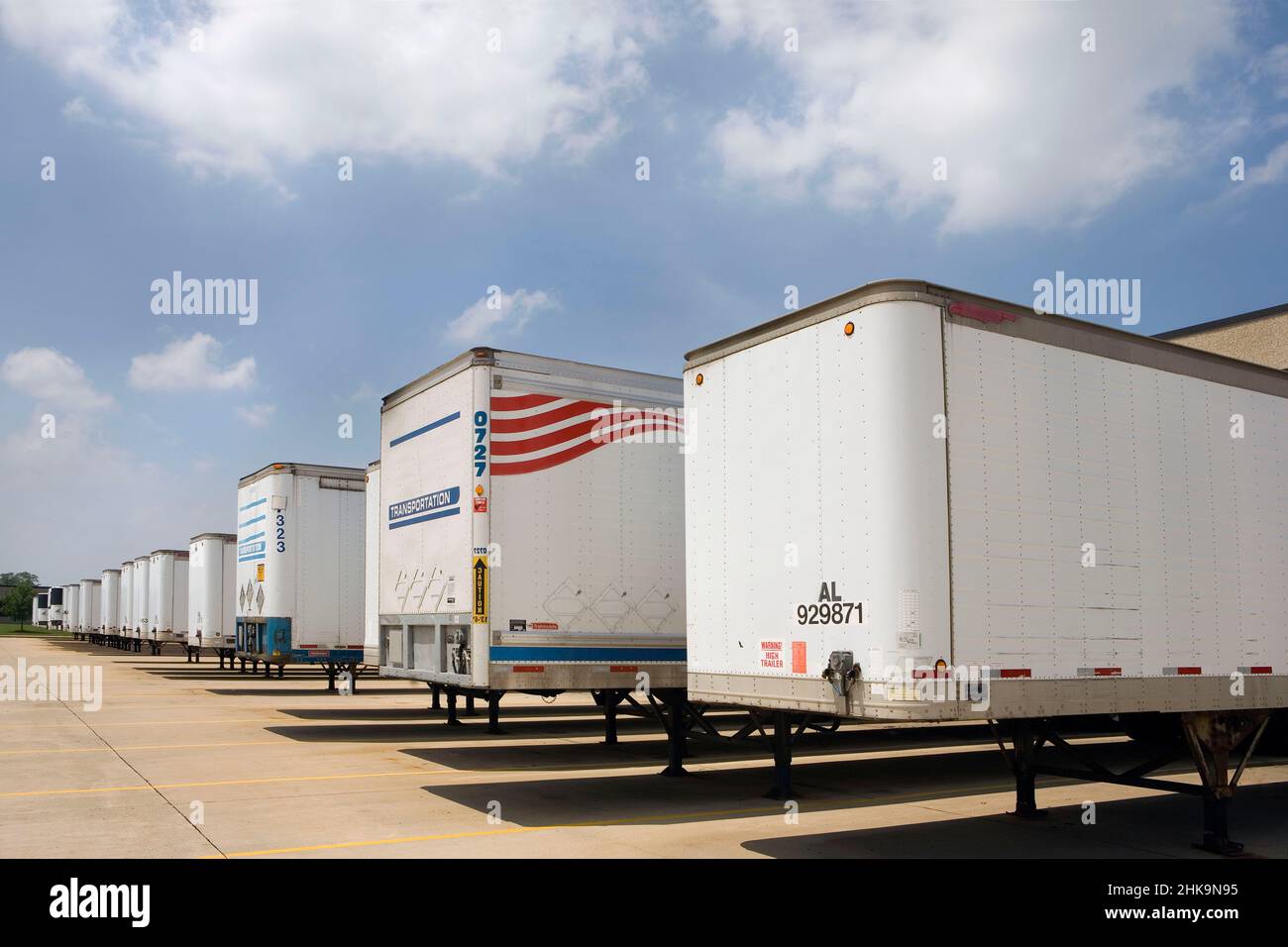 A line of semi-truck trailers at a shipping terminal H Stock Photo - Alamy