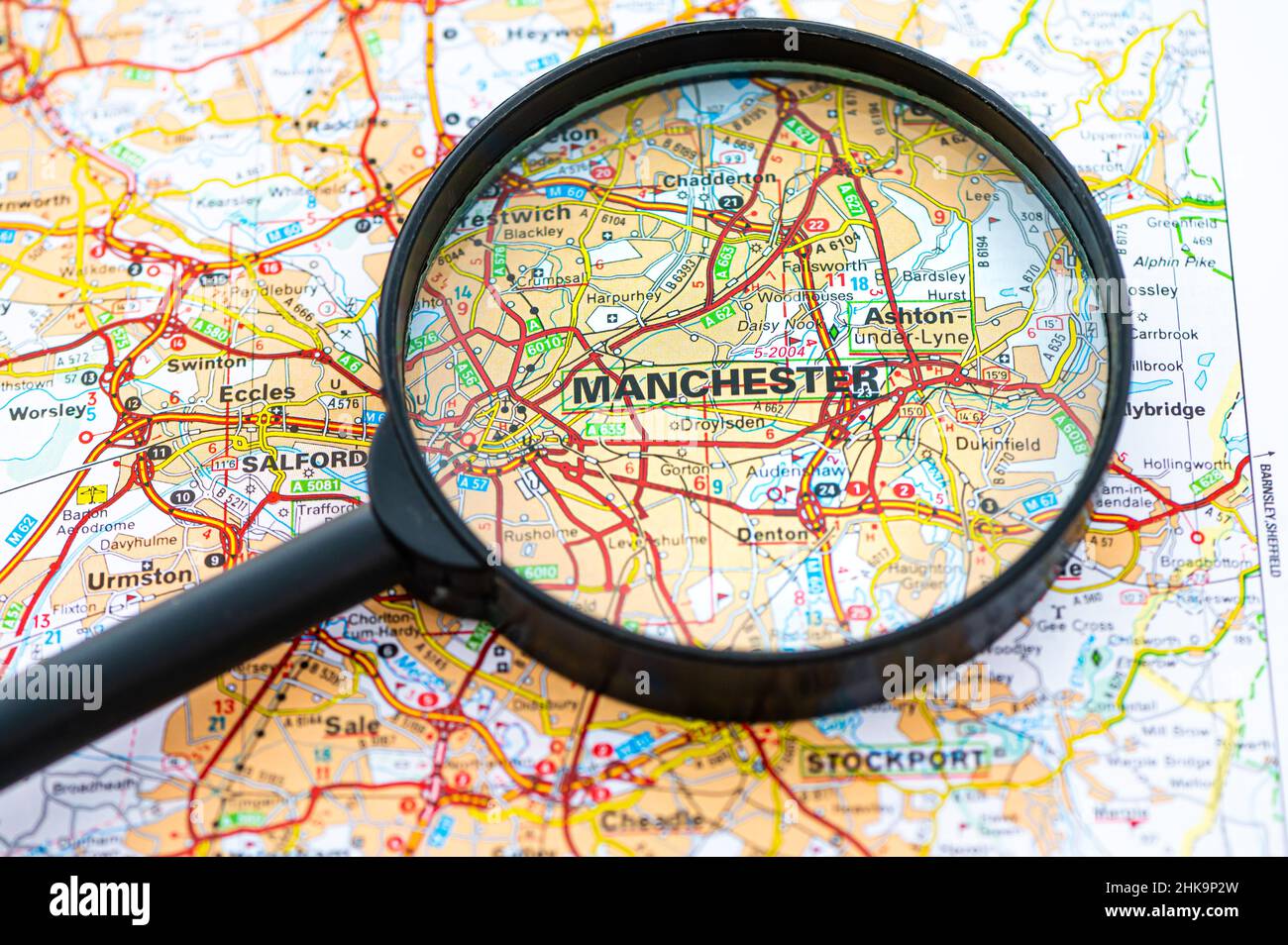 map of Manchester in England through magnifying glass, concept of ...