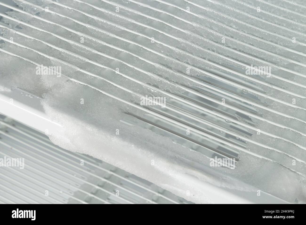 Ice in the freezer on the shelves of the refrigerator is melting and ...