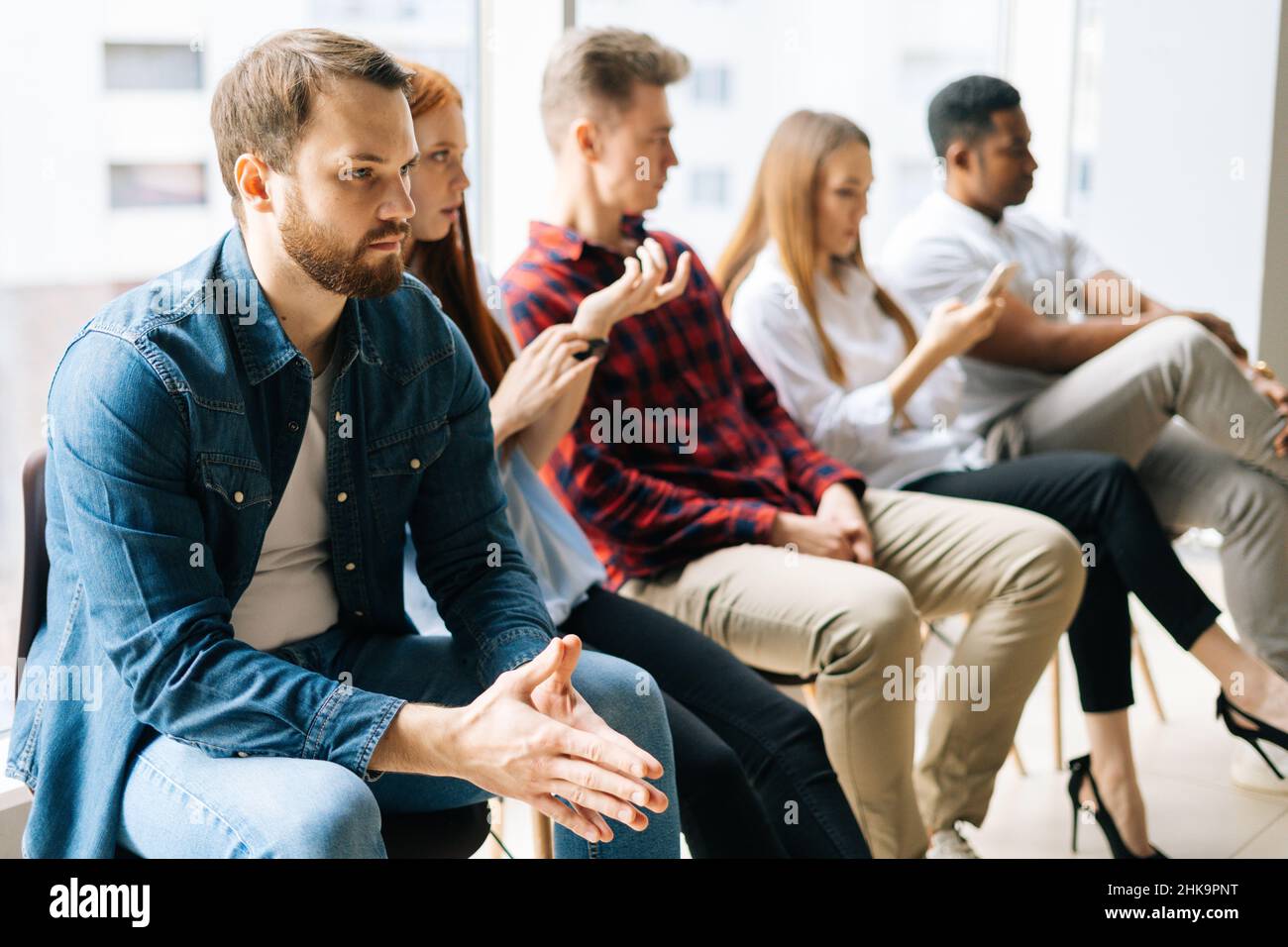 Group of stressed young diverse multi-ethnic job candidates in casual ...