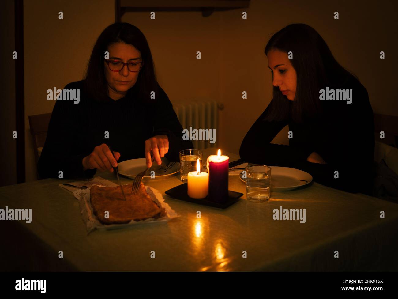 Young females eating by candlelight Stock Photo - Alamy