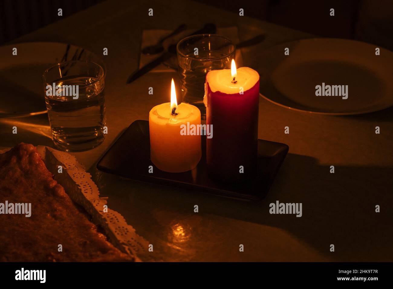 Table set for dinner by candlelight Stock Photo - Alamy