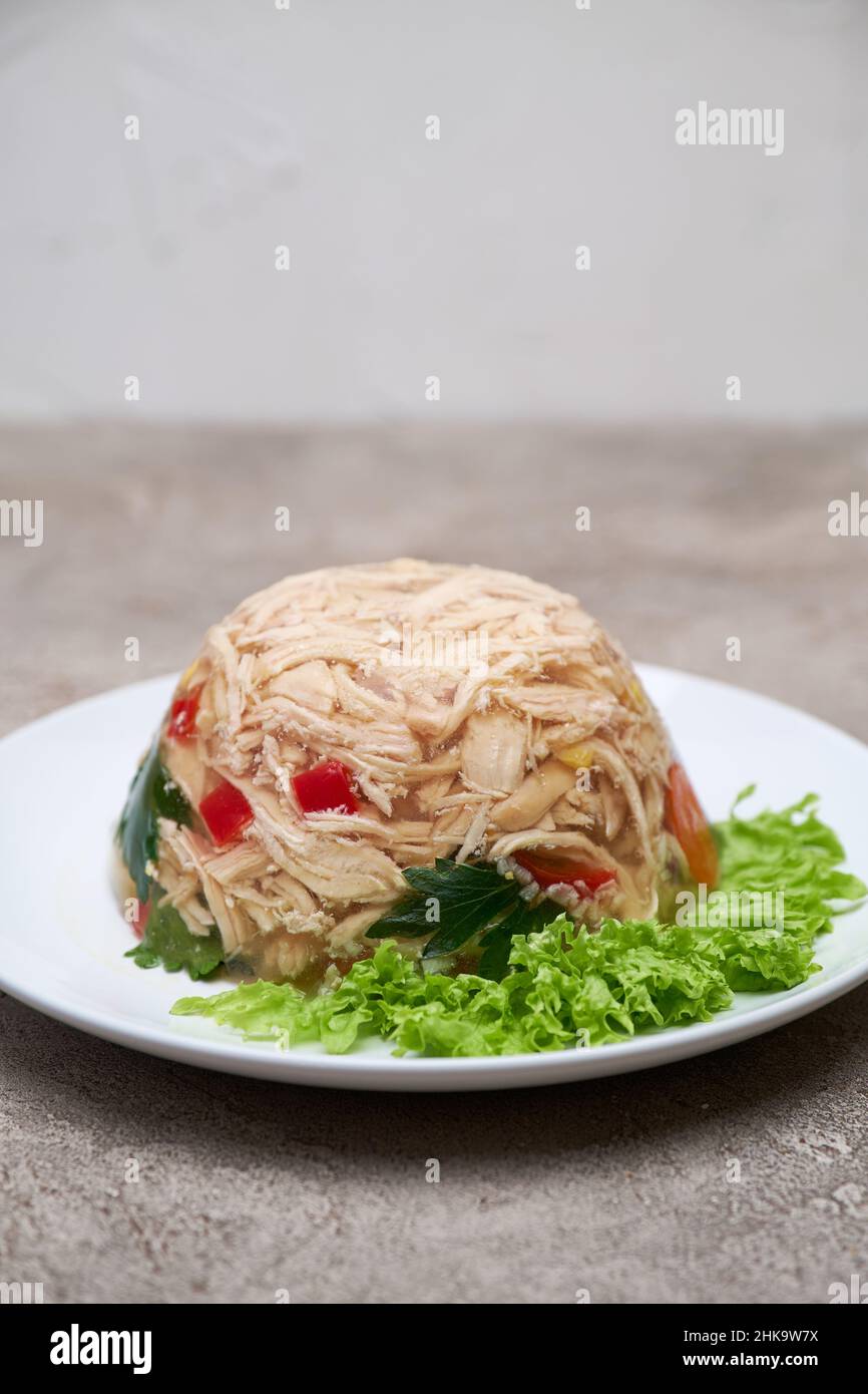 Delicious chicken aspic on a plate on concrete table Stock Photo - Alamy