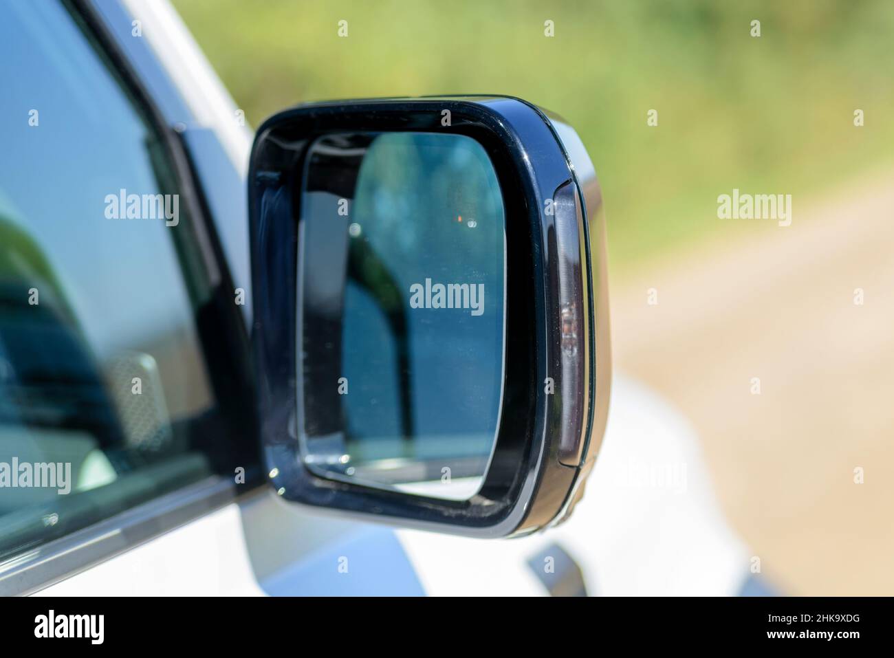 Close-up of the side right mirror and window of the car body white SUV ...