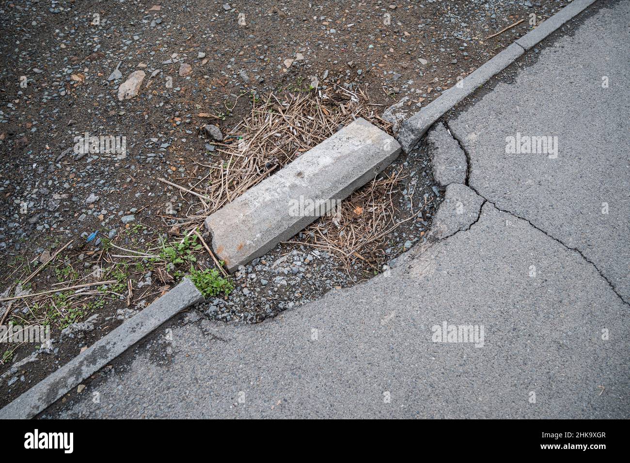 Old and broken sidewalk at street Stock Photo - Alamy