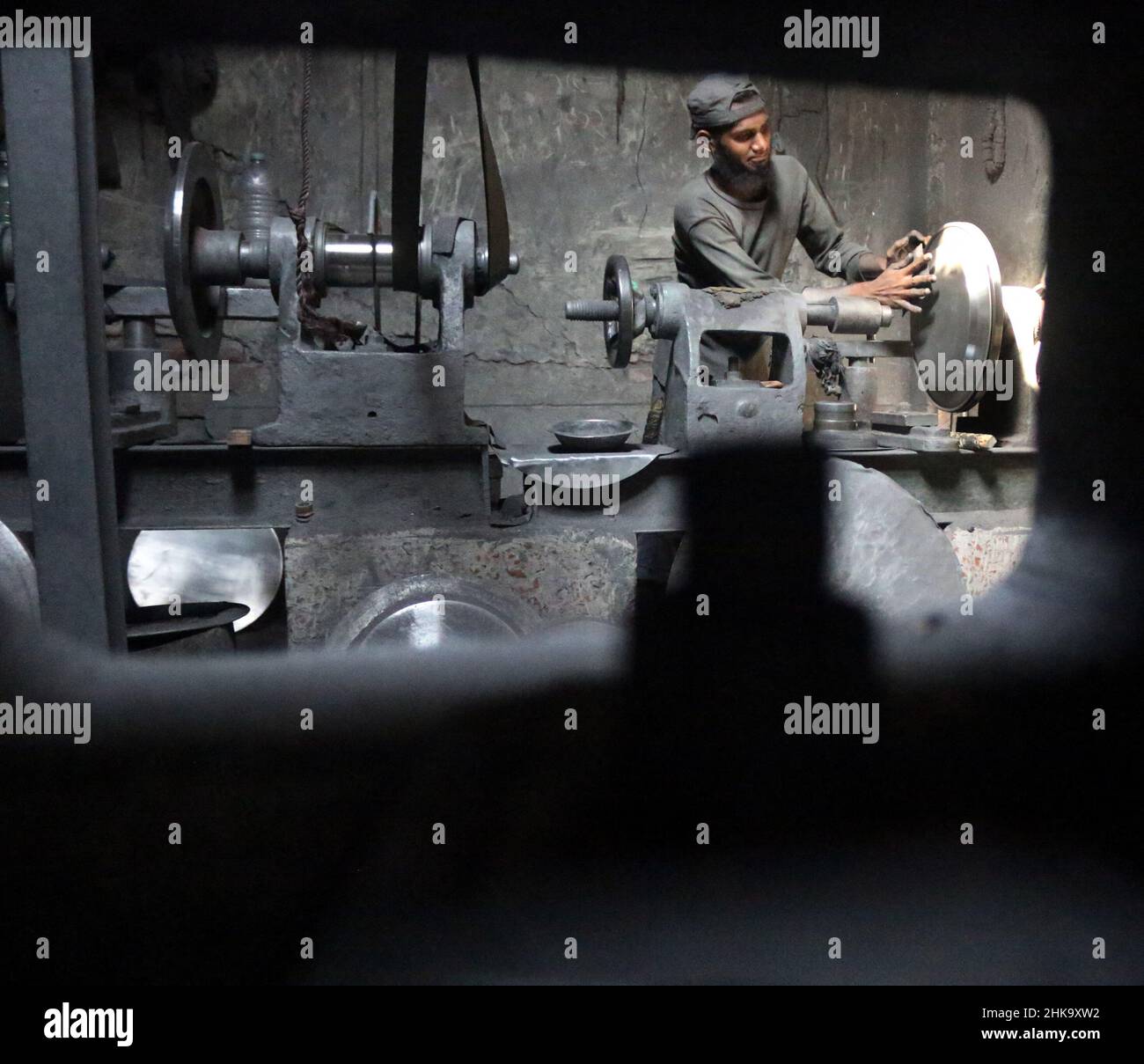 Workers make utensils in an unhealthy environment at an aluminium ...