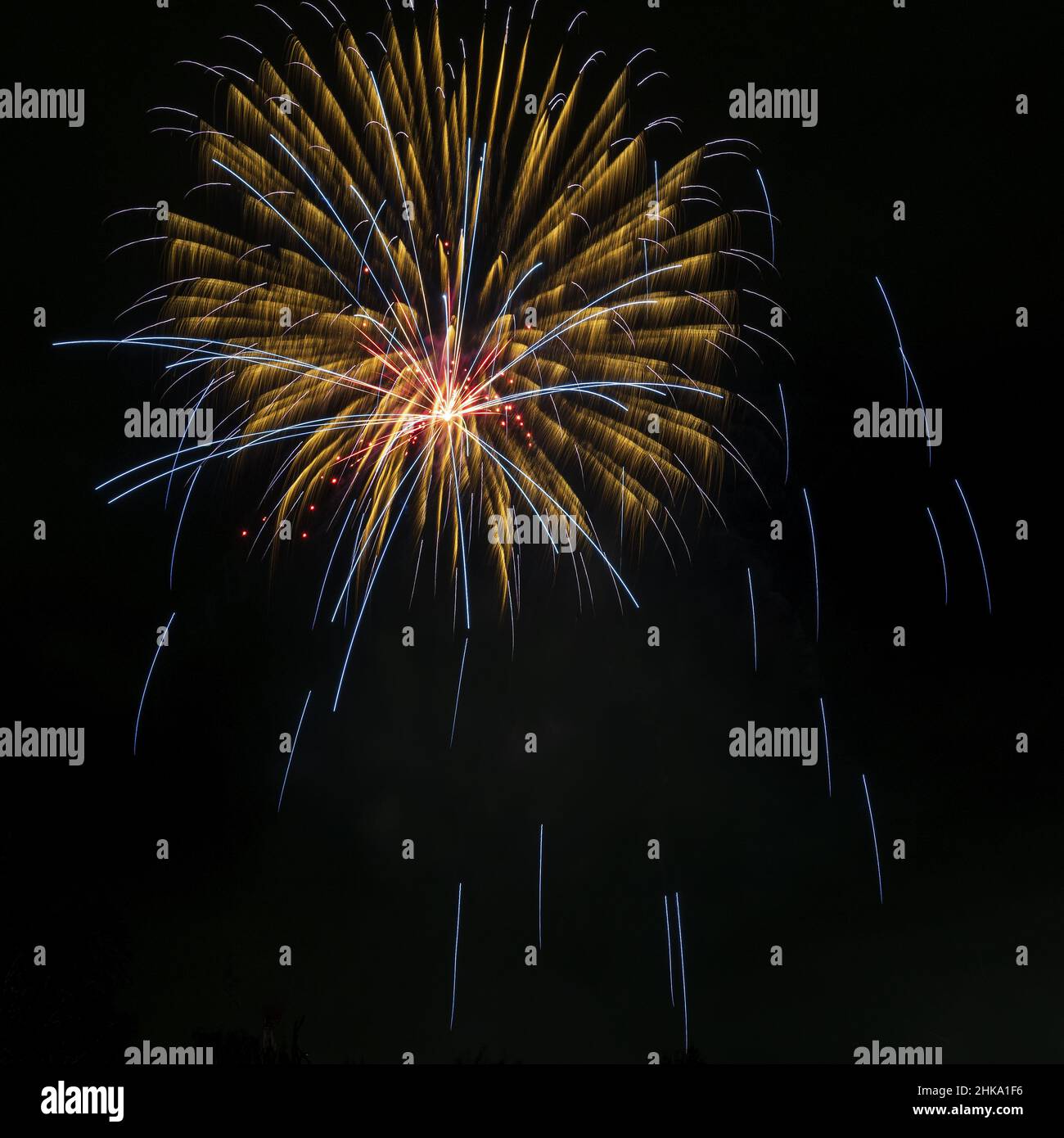 Beautiful fiery rays of light from explosion of pyrotechnics on black ...