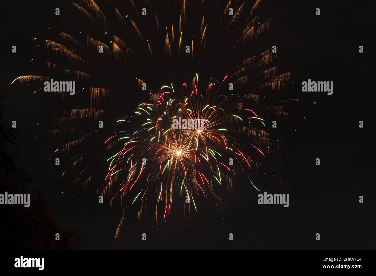 Beautiful fiery rays of light from explosion of pyrotechnics on black ...