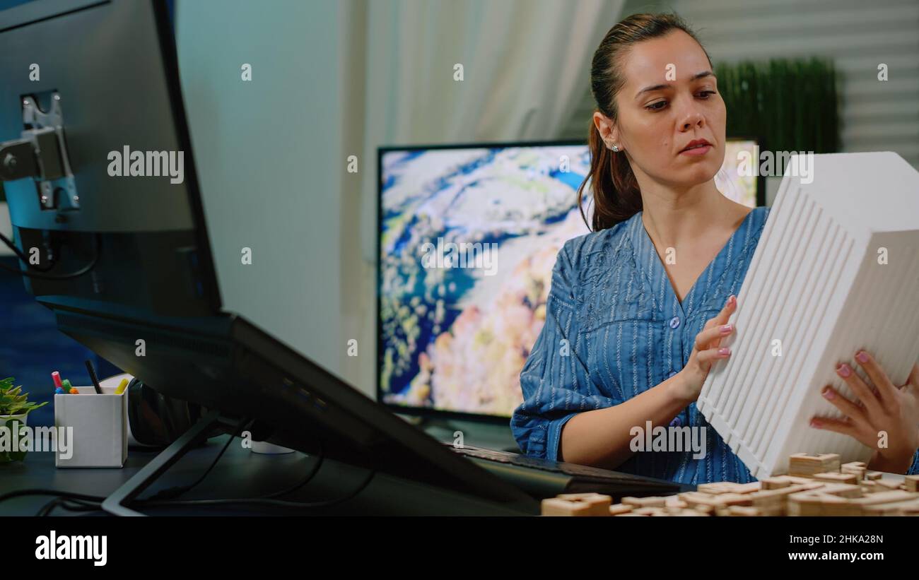 Woman Architect Holding Maquette And Using Computer With Touch Screen For Architectural