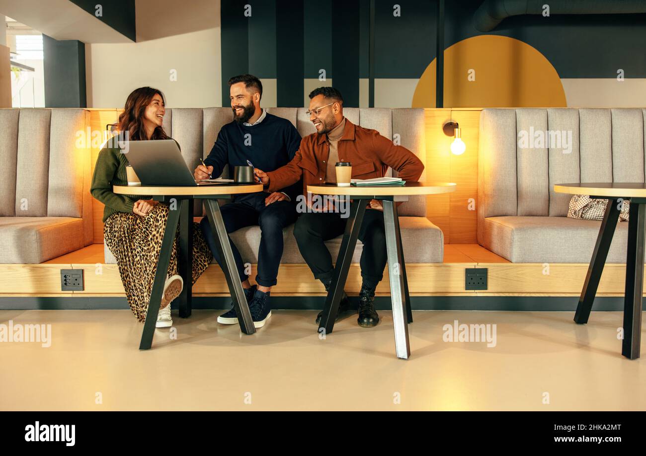 Modern entrepreneurs working together in a lobby. Team of happy ...