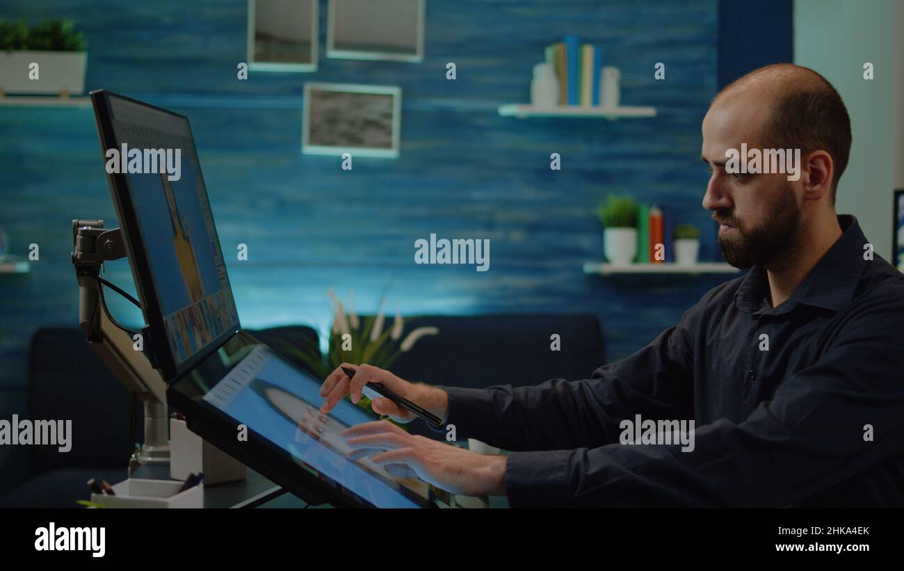 Photography artist using editing software on touch screen for media ...