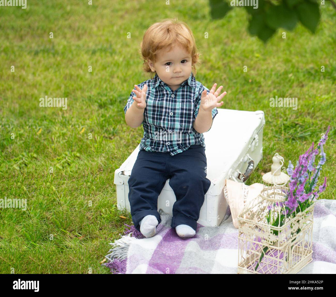 Little baby playing in nature on the green grass. Kids playing. Baby ...