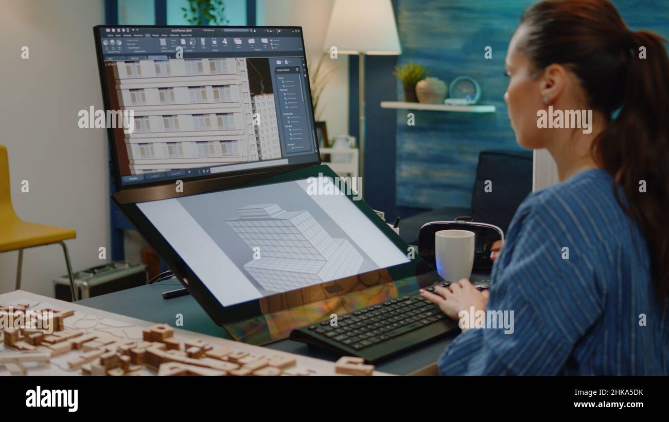 Businesswoman working on building model with touch screen in ...