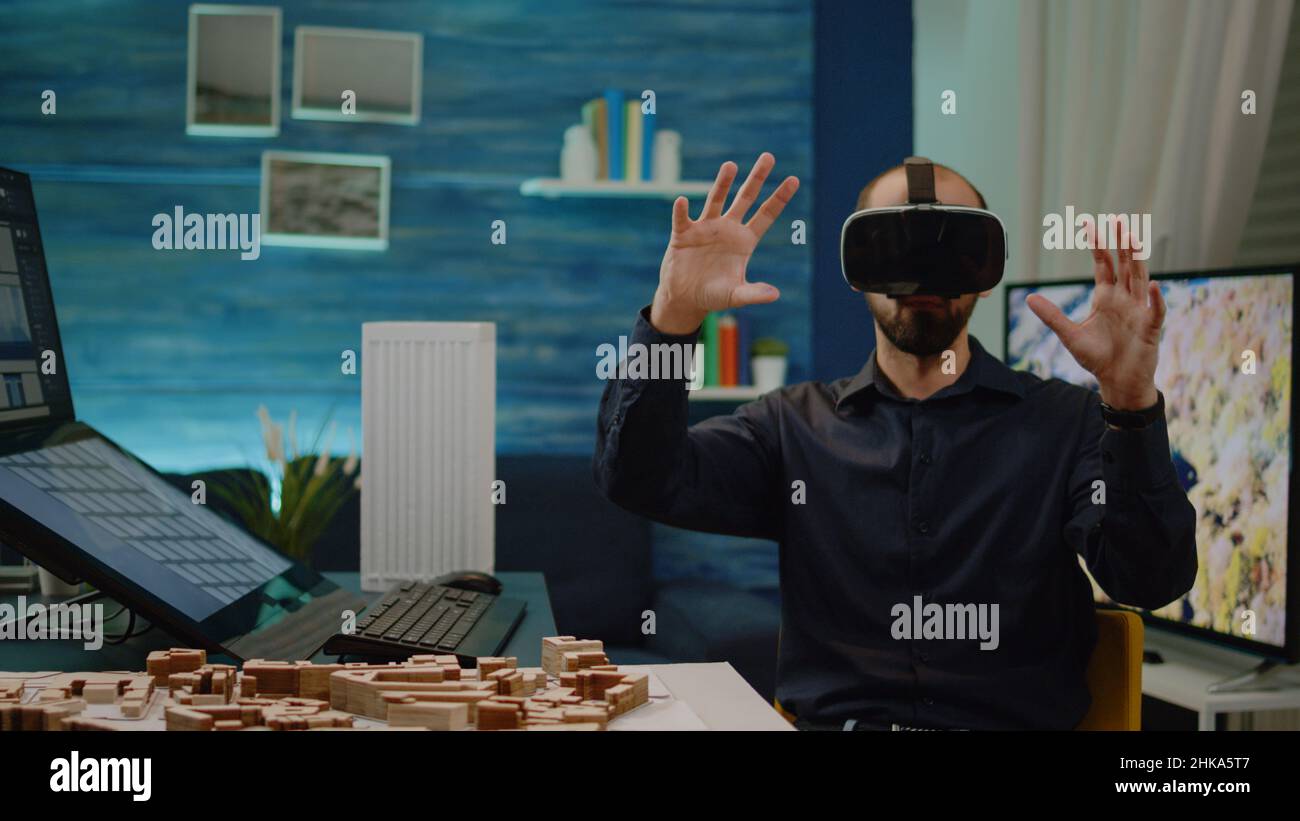 Modern architect using vr glasses for building model and construction ...