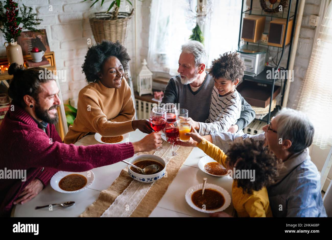 Happy multiethnic multigeneration family having fun together around ...