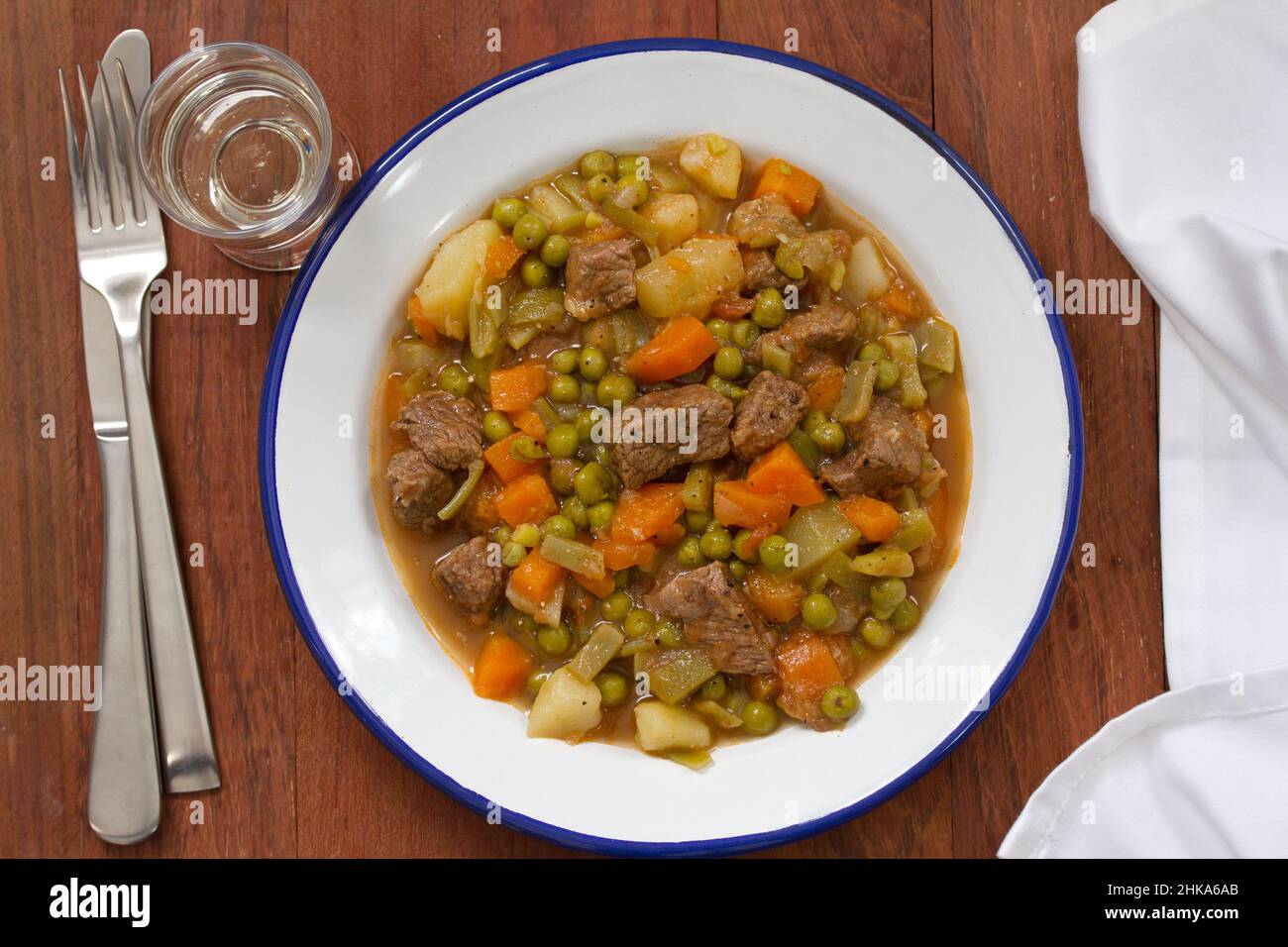 meat with carrot, peas and potato on white dish Stock Photo - Alamy
