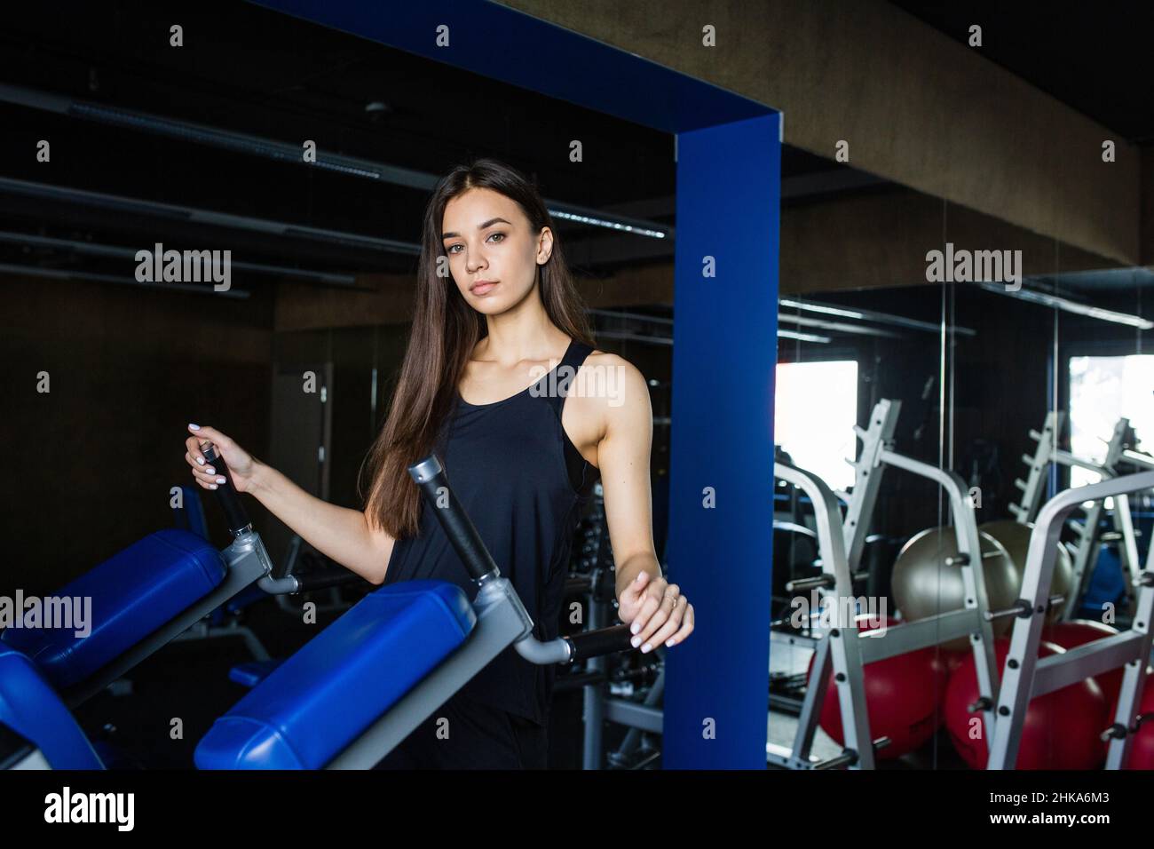 Young beautiful woman performs exercise in modern gym club Stock Photo ...