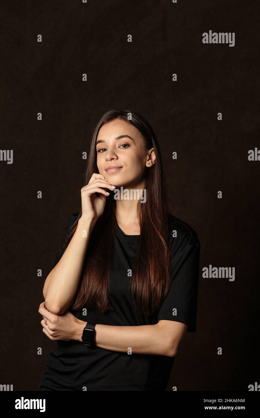 Sporty attractive young woman in special sportswear posing at dark ...