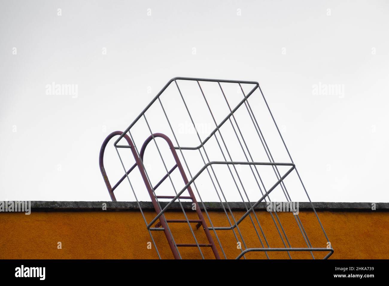 Fire escape on the top of a building, steel cage ladder Stock Photo - Alamy