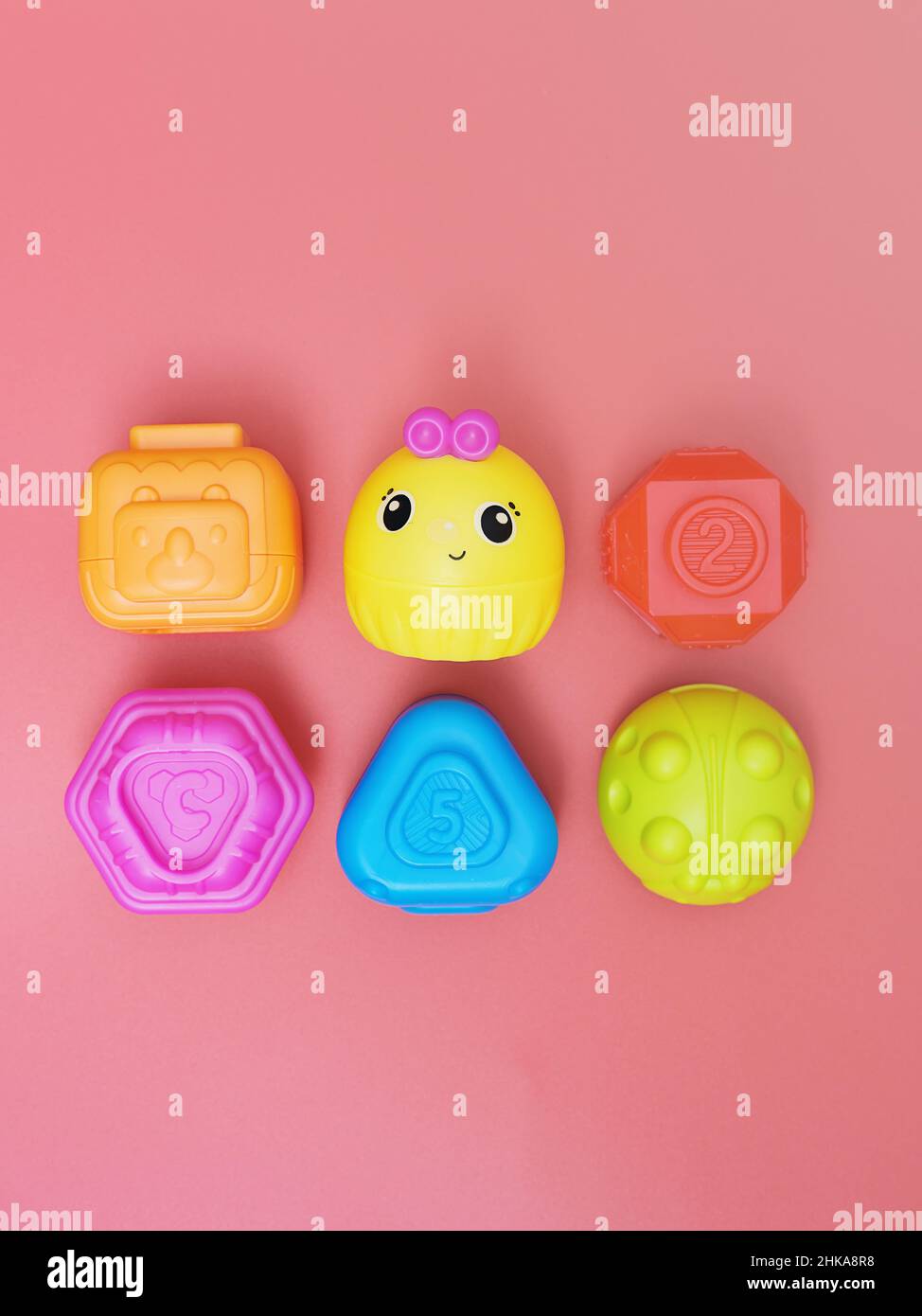 kids plastic toys on red background. geometric shapes and animals for ...