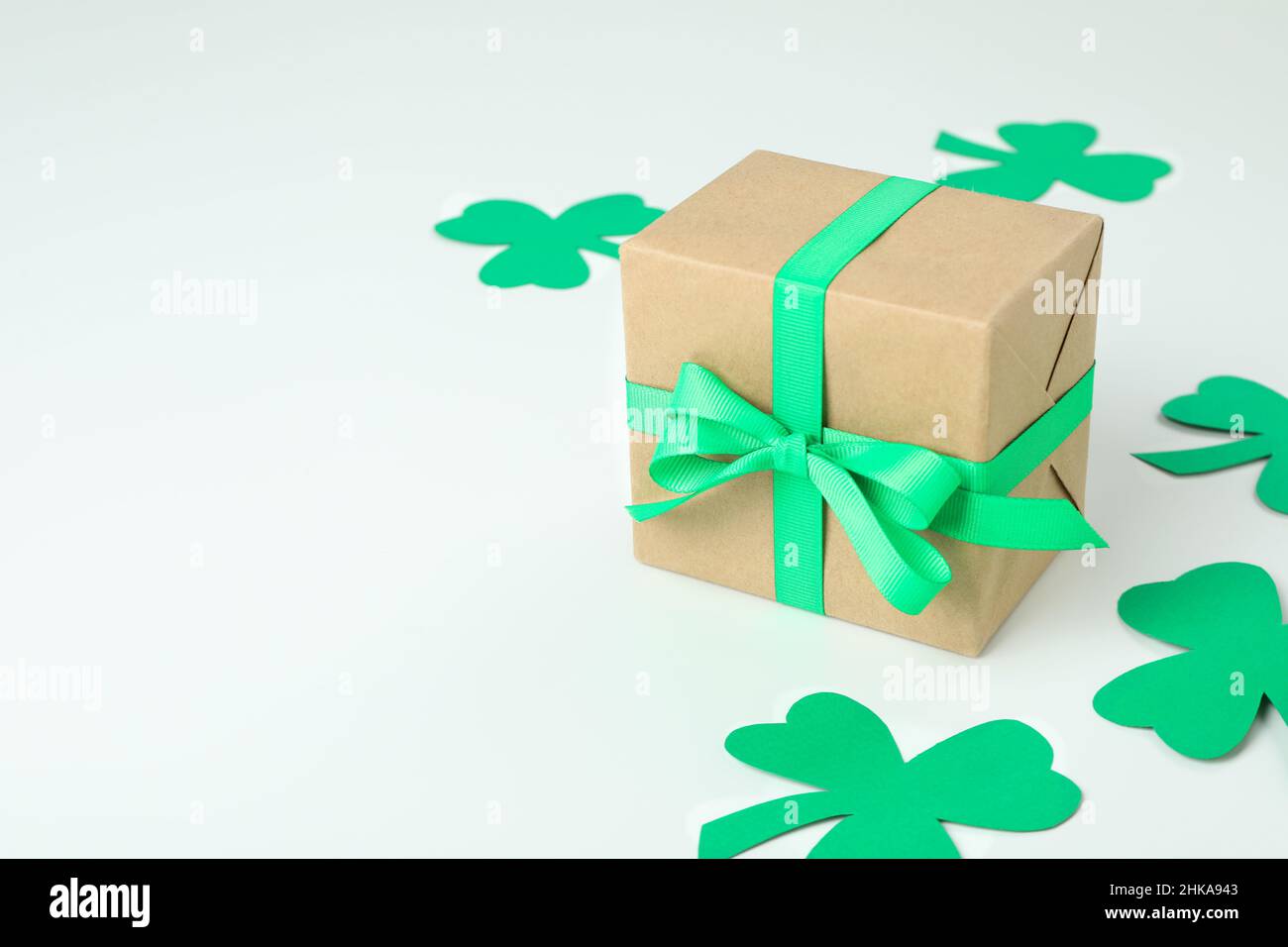 Clover leaves and gift box on white background Stock Photo - Alamy