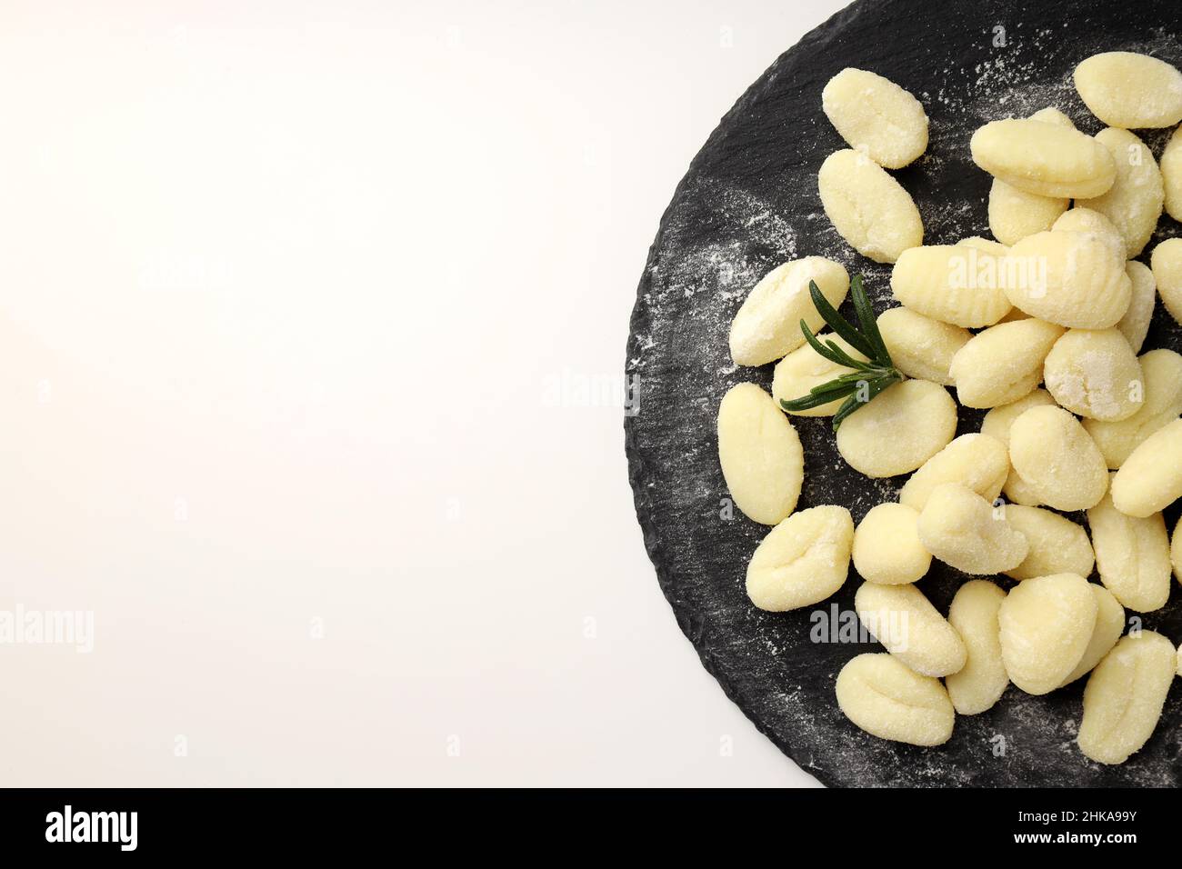 Tray with raw potato gnocchi on white background Stock Photo - Alamy
