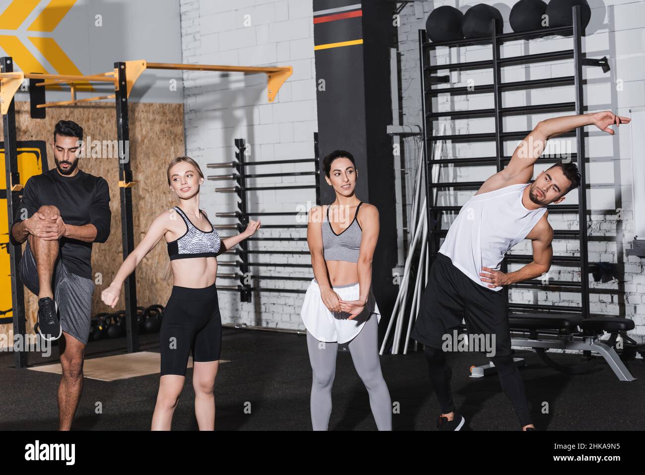 Young multiethnic people working out together in gym Stock Photo - Alamy