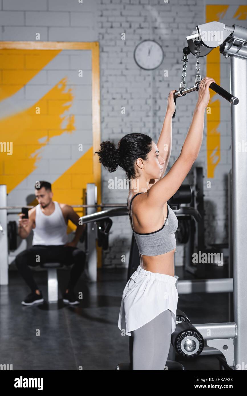 Middle east woman training on lat pulldown machine in gym Stock Photo ...