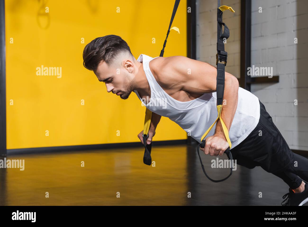 Bearded man training suspension straps hi-res stock photography and ...