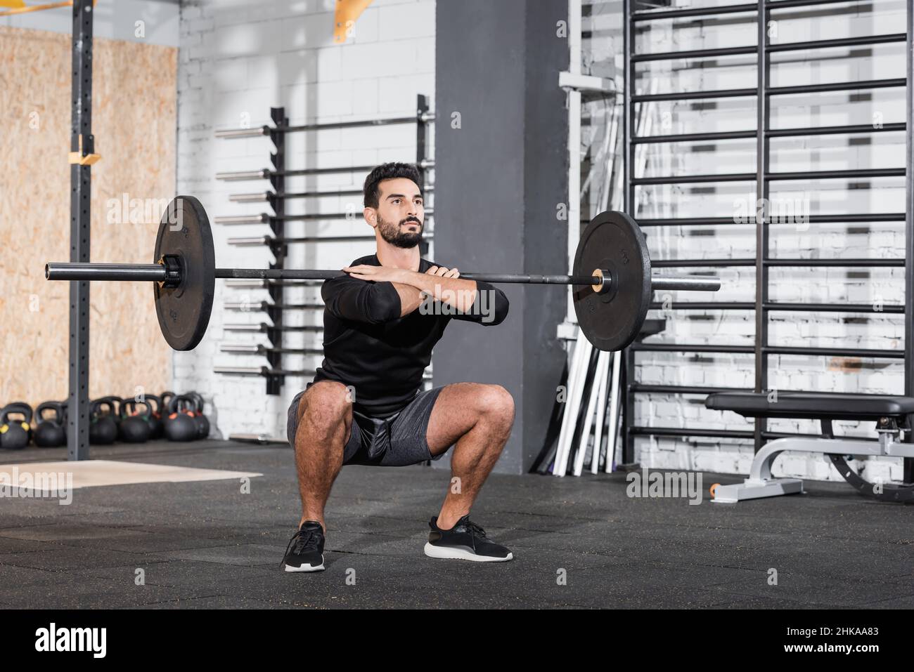 Arabian sportsman lifting barbell in gym Stock Photo - Alamy