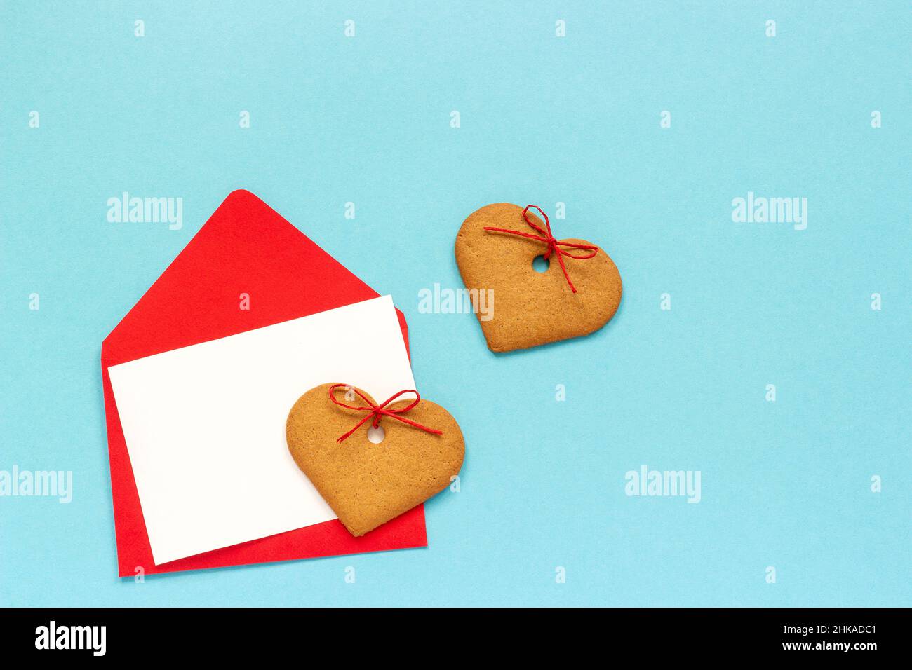Red envelope with blank white card for text and heart shaped ginger ...