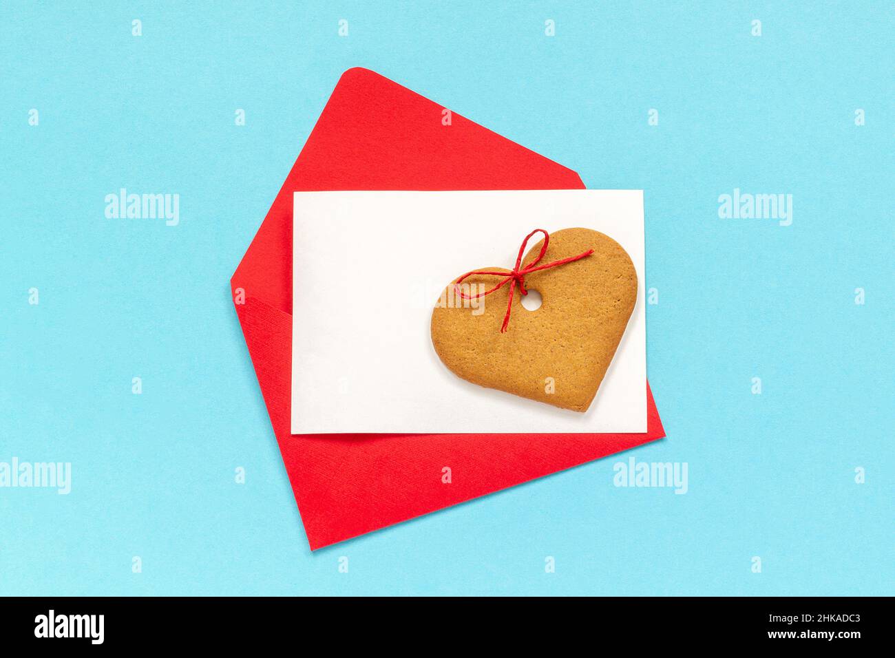 Red envelope with blank white card for text and heart shaped ginger ...
