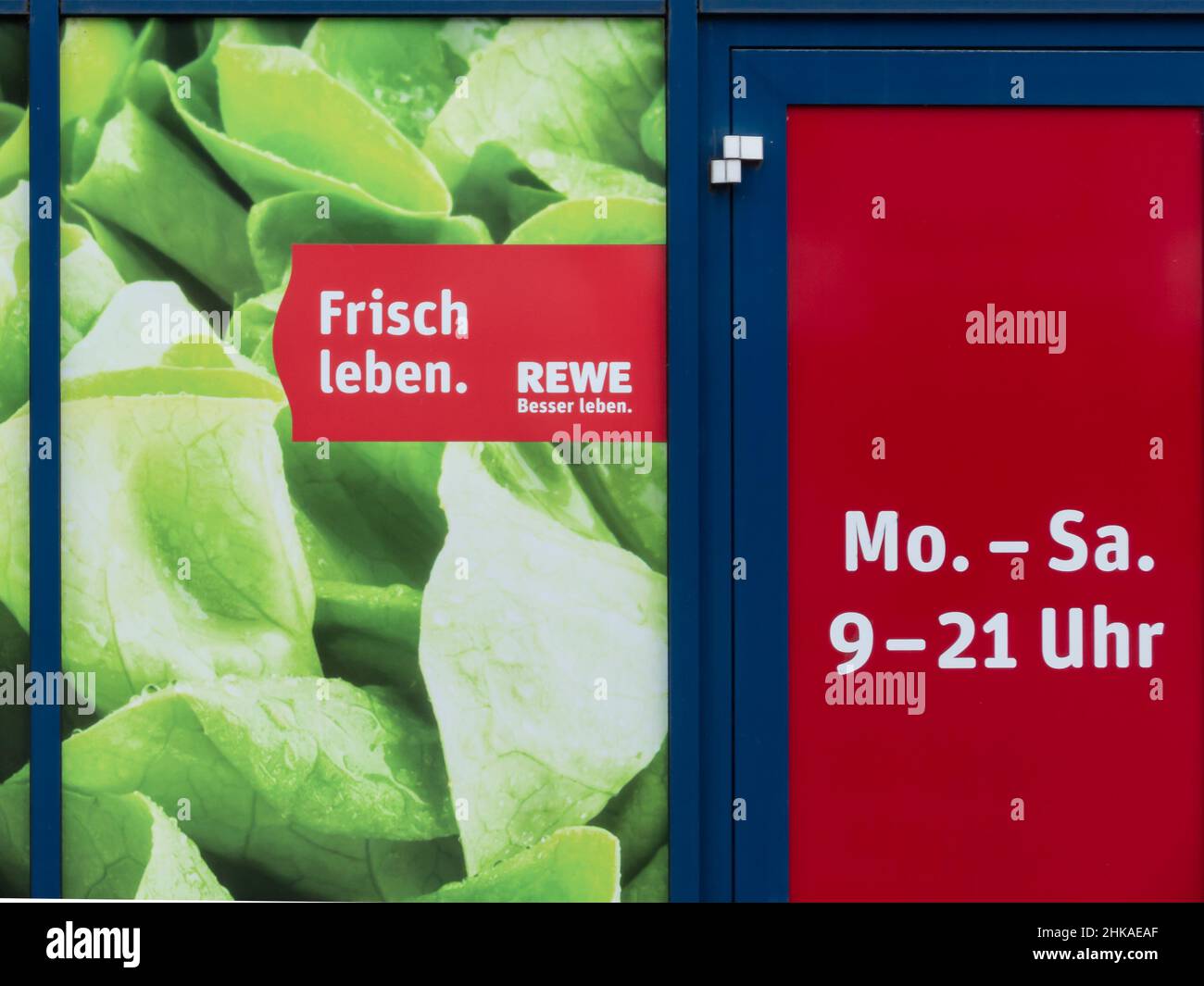 a shop window with a sheet sticked onto a shop window of a REWE food ...
