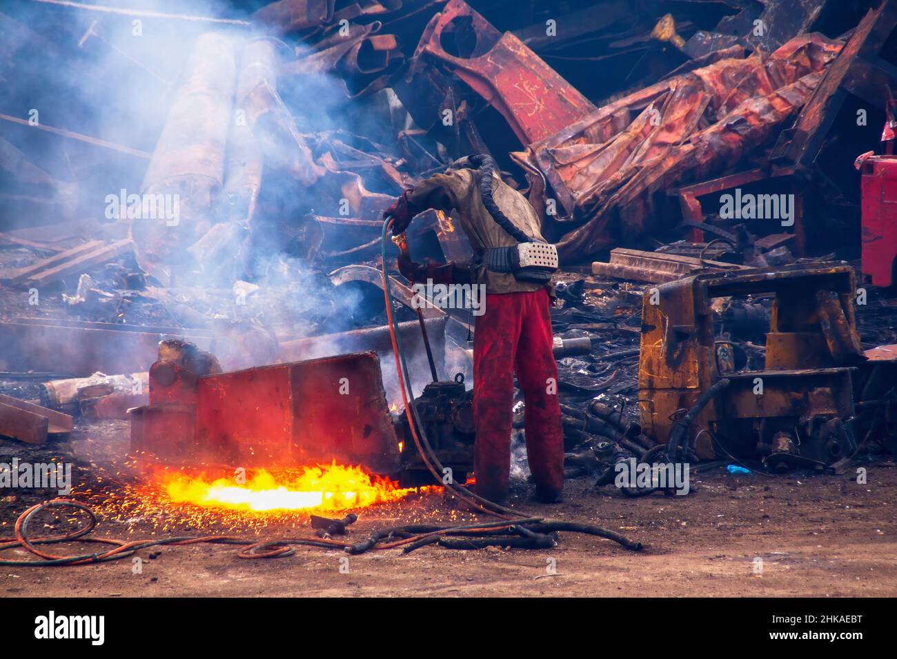 A single man cutting scrap steel with a gas cutting torch Stock Photo ...