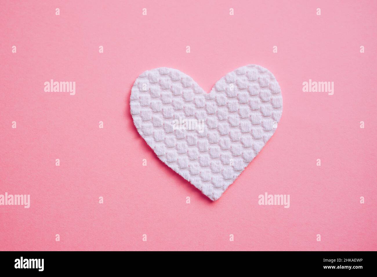 White fabric heart on pink table, top view Stock Photo - Alamy