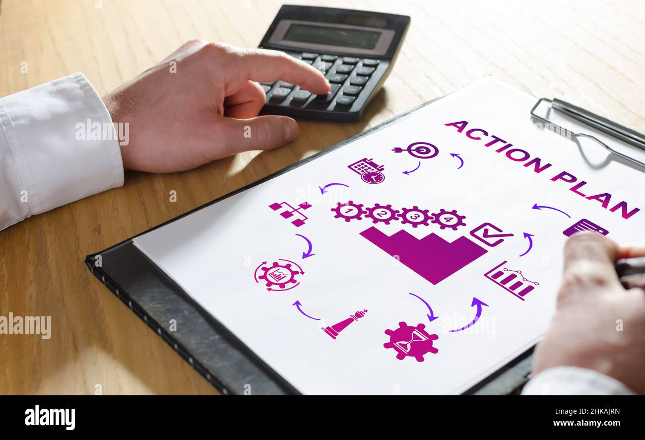 Action plan concept with hand using a calculator Stock Photo - Alamy