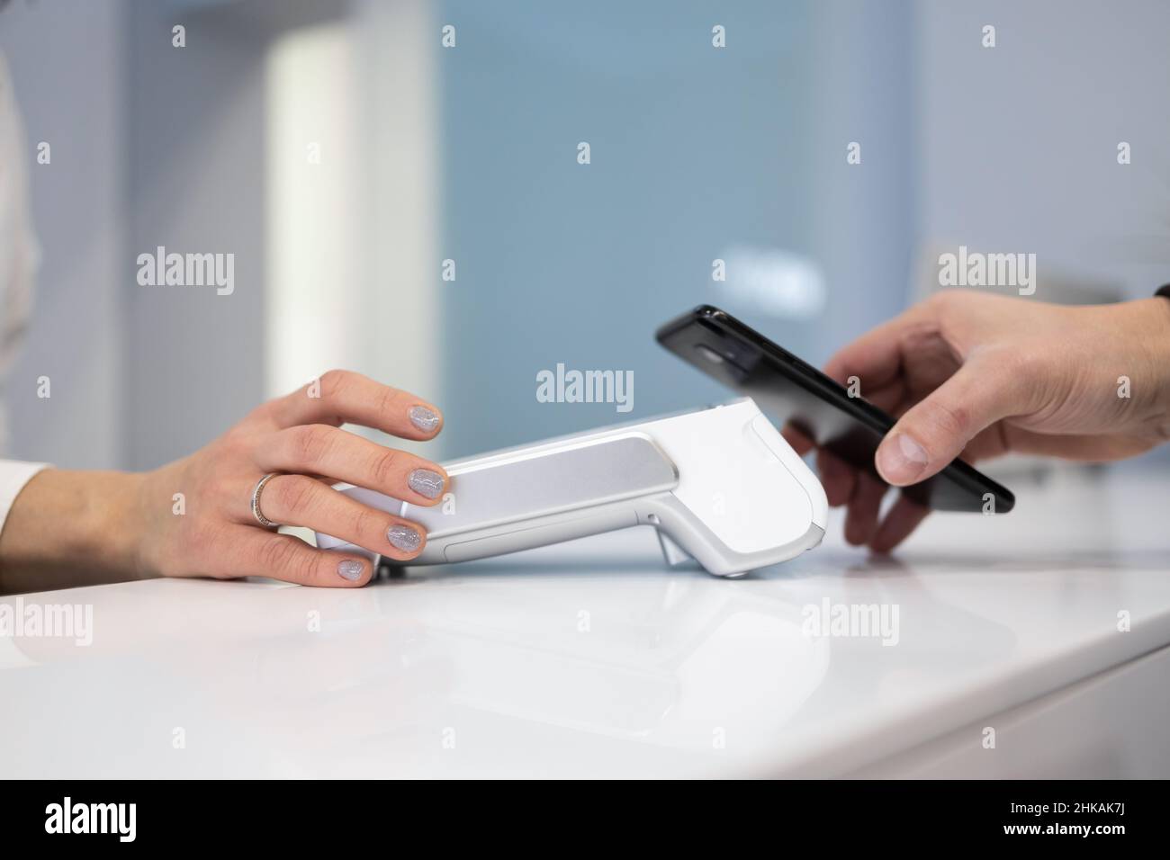 Customer paying by smartphone with NFC technology in POS terminal Stock ...