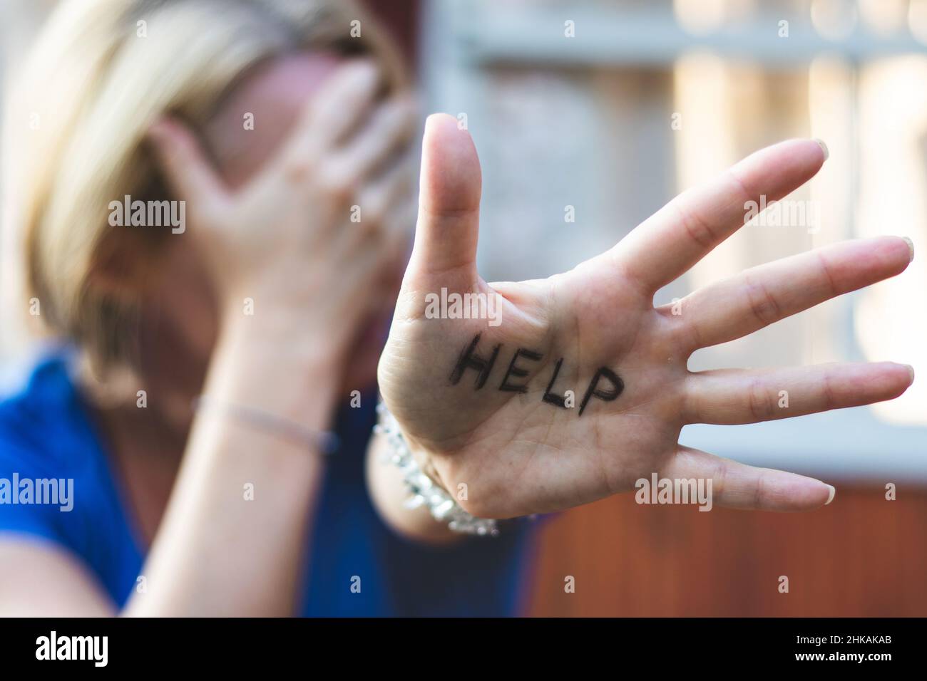 Woman gesturing help sign on her hand. Depression concept Stock Photo ...