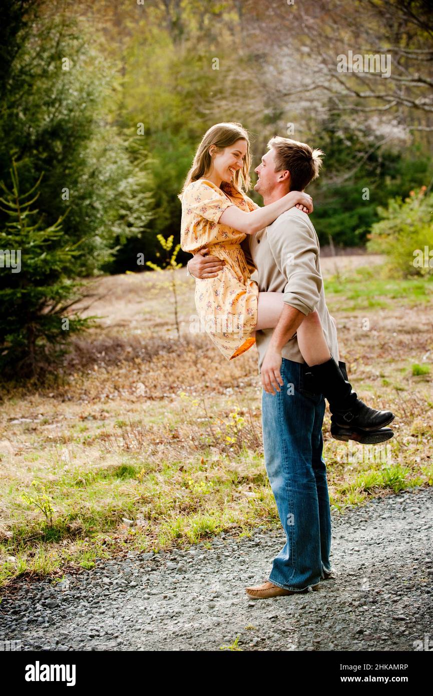 Young woman jumping into man's arms Stock Photo - Alamy