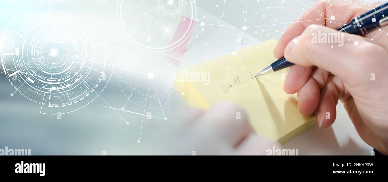 Businessman taking notes on a post-it; panoramic banner Stock Photo - Alamy