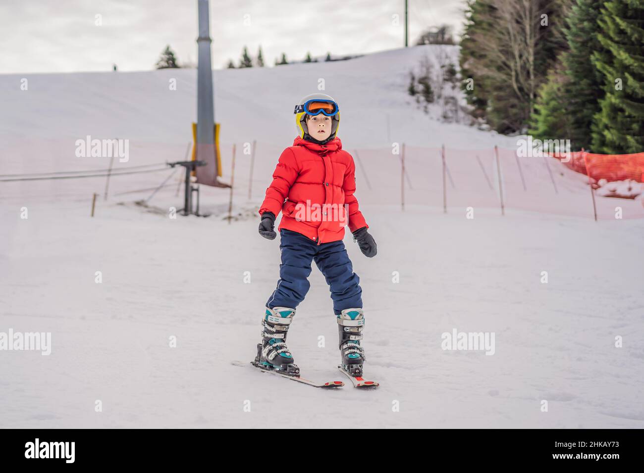 Child skiing in mountains. Active toddler kid with safety helmet ...