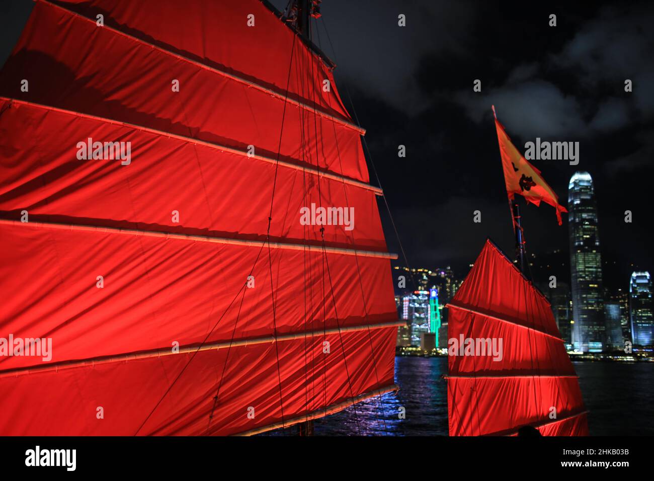 Chinese red junk with the victoria harbor night view background in hong ...