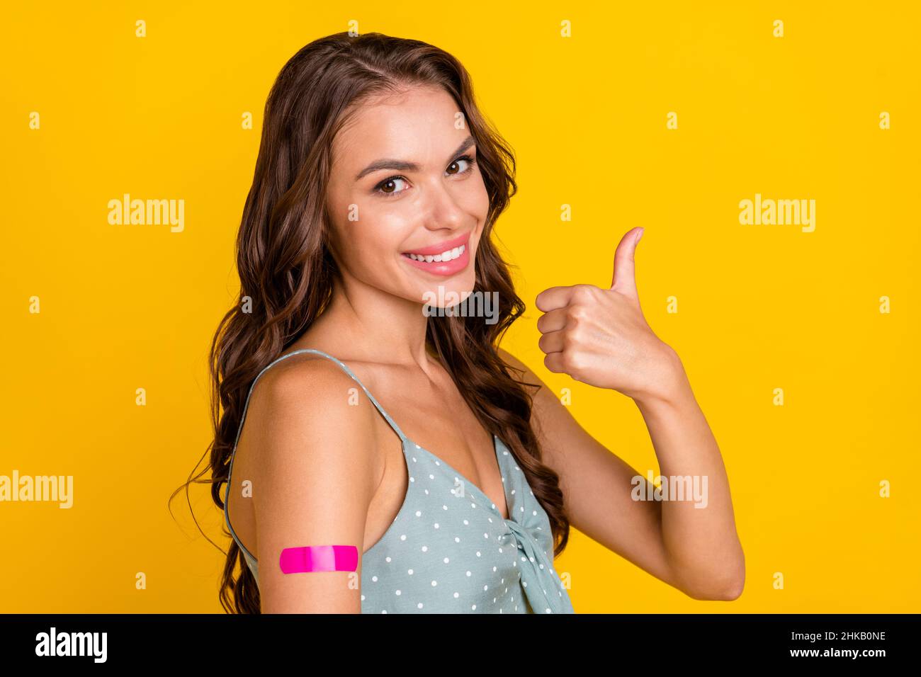 Photo Of Young Brunette Woman Show Thumb Up Wear Dotted Singlet Vaccine