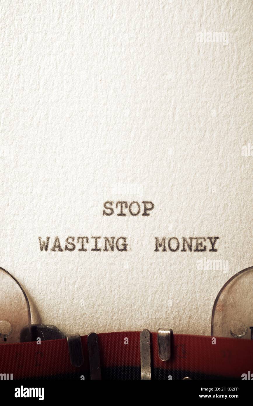 Stop wasting money text written with a typewriter Stock Photo - Alamy