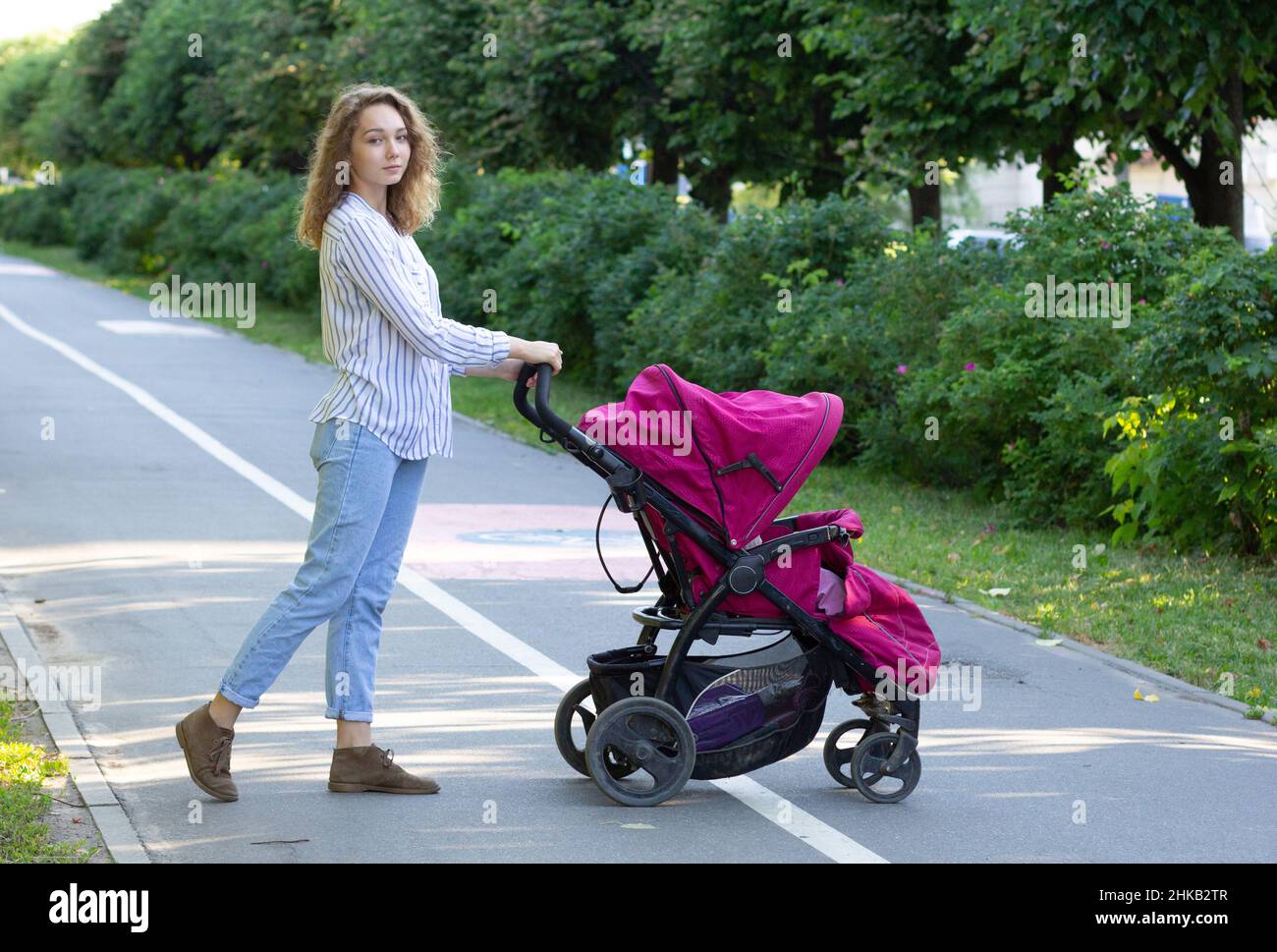 Young mother with newborn in stroller Stock Photo - Alamy