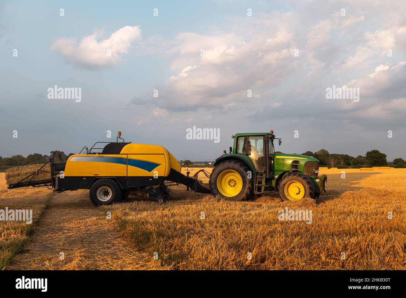 Process of hay making during harvesting Stock Photo - Alamy