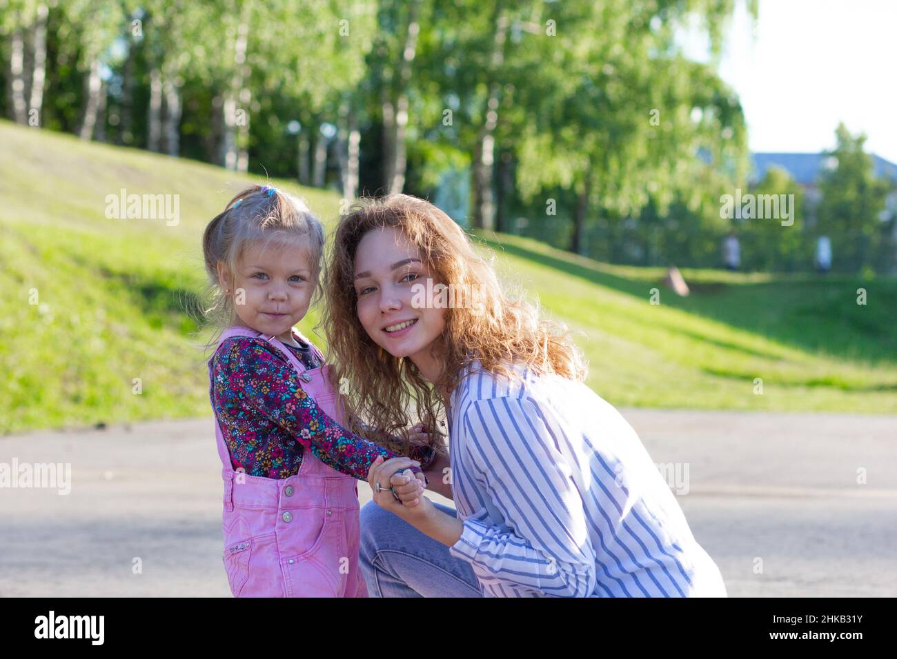Young girl holding hands with smiling and beautiful child Stock Photo ...