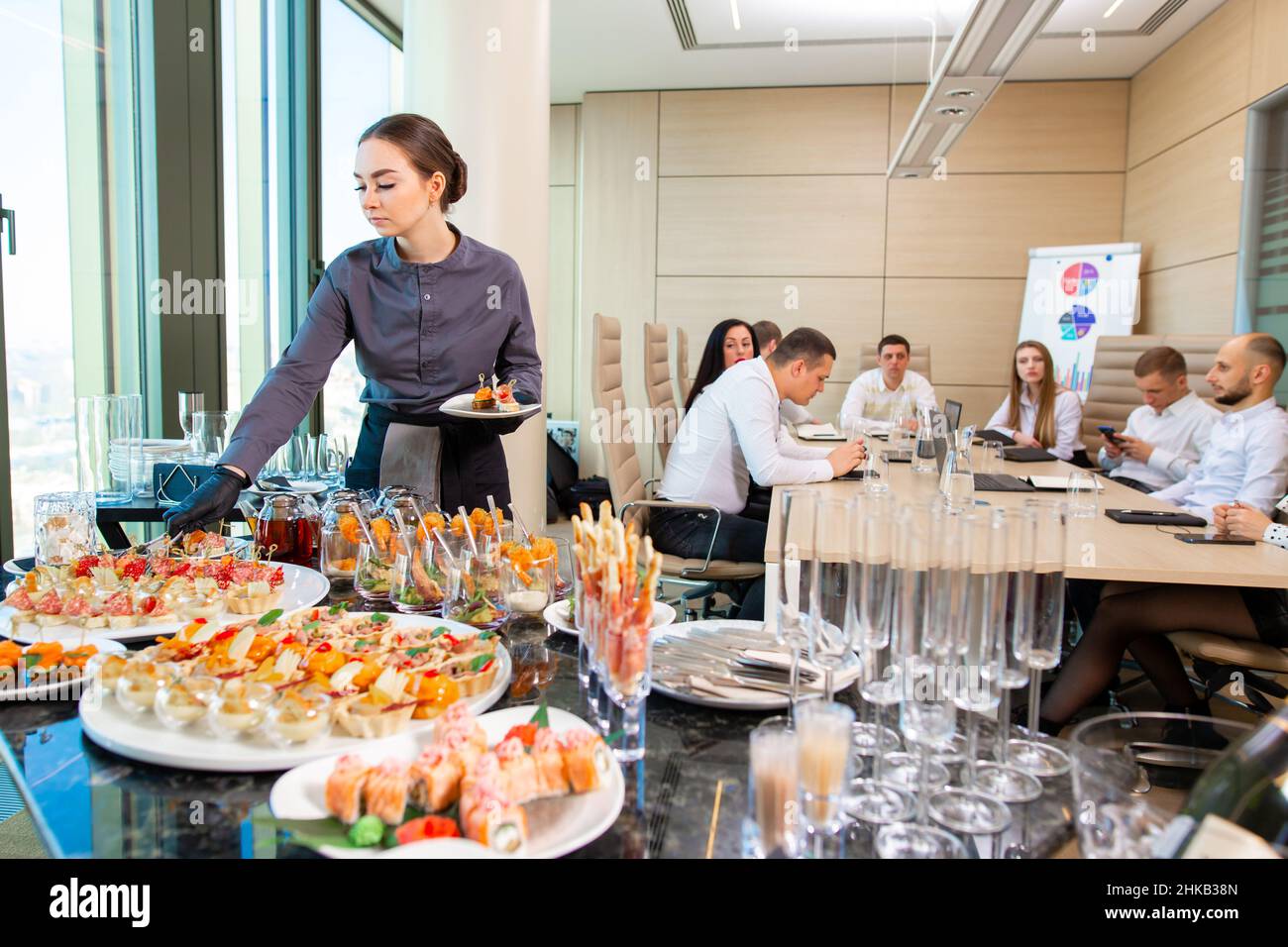 a restaurant waiter serves an off-site banquet in the office Stock ...
