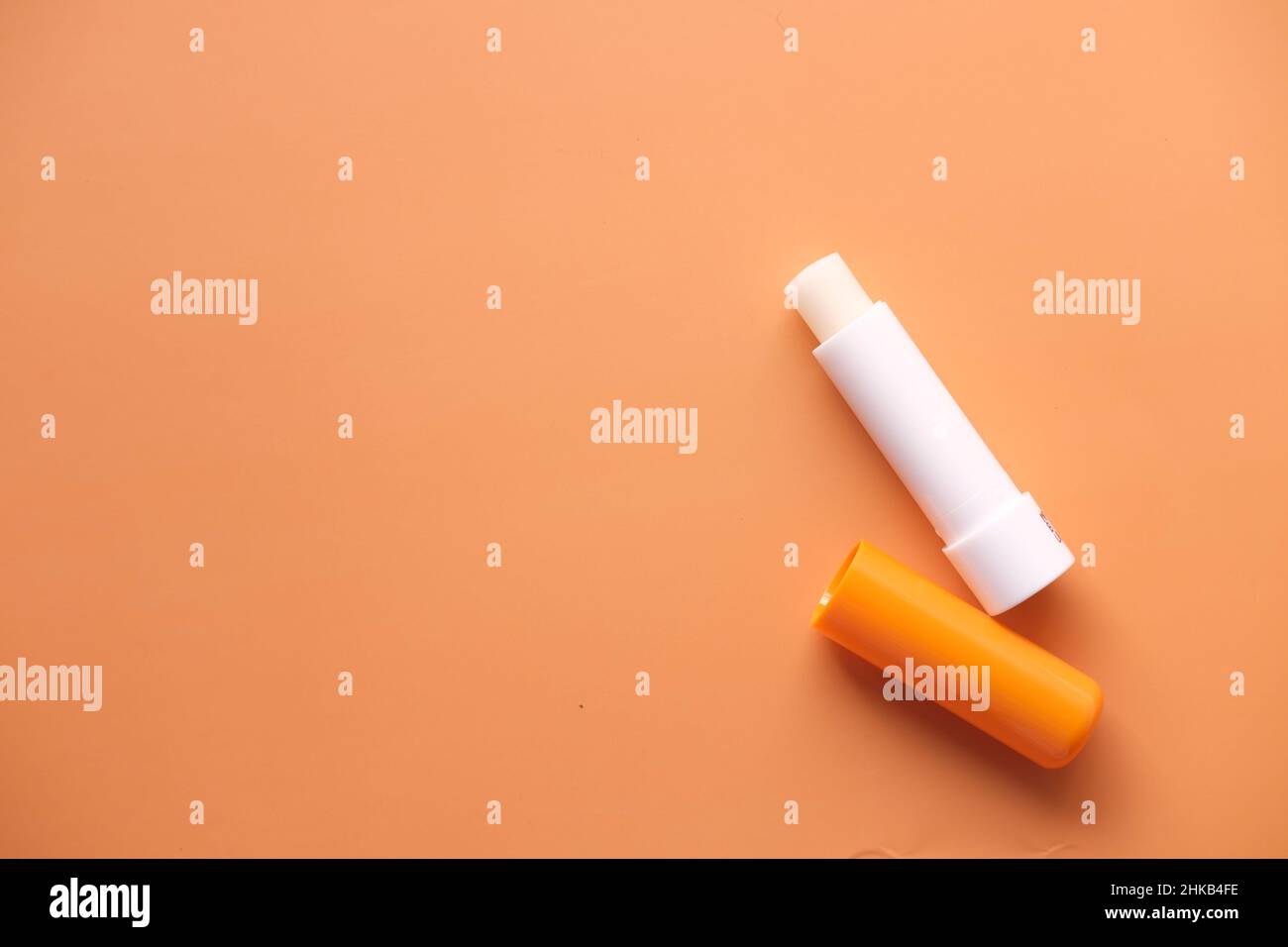 moisturising lip balm on a orange background Stock Photo - Alamy