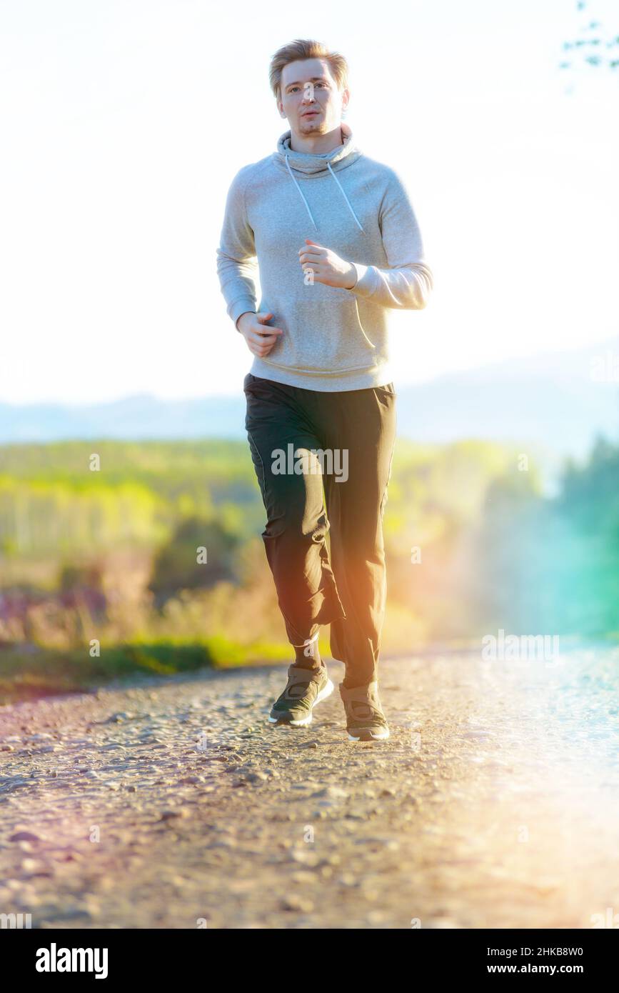 Running man jogging in rural nature at beautiful summer day. Sport ...